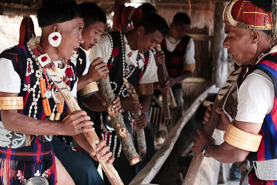 Tribesmen from the Sangtam naga tribe beating the logdrum at their Morung